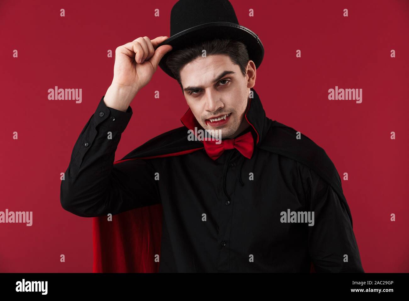 Image of vampire man with blood and fangs in black halloween costume ...