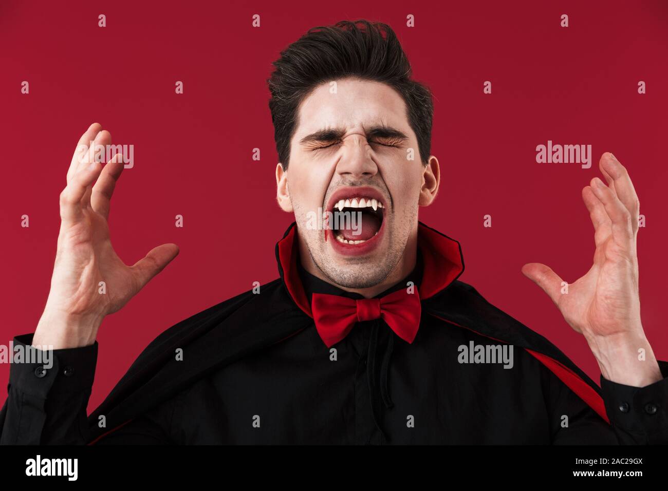 Image of angry vampire man with blood and fangs in black halloween ...