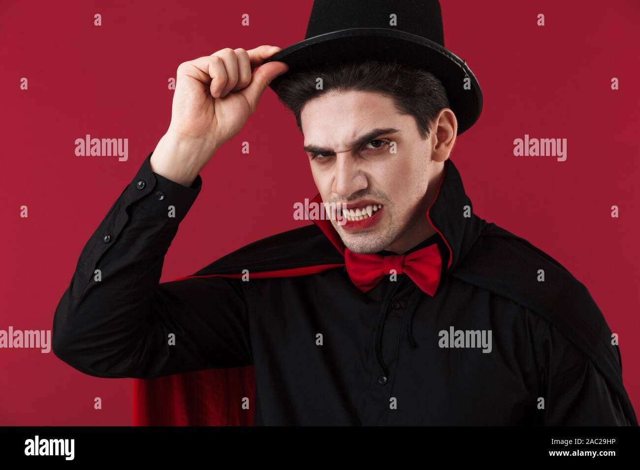 Image of vampire man with blood and fangs in black halloween costume ...