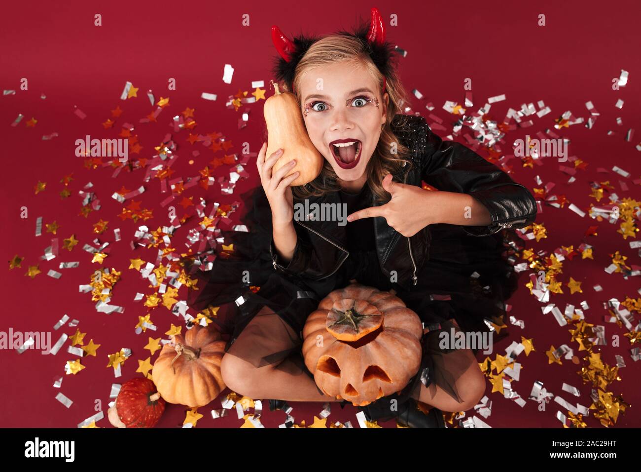 Picture of shocked surprised little girl devil in carnival halloween ...