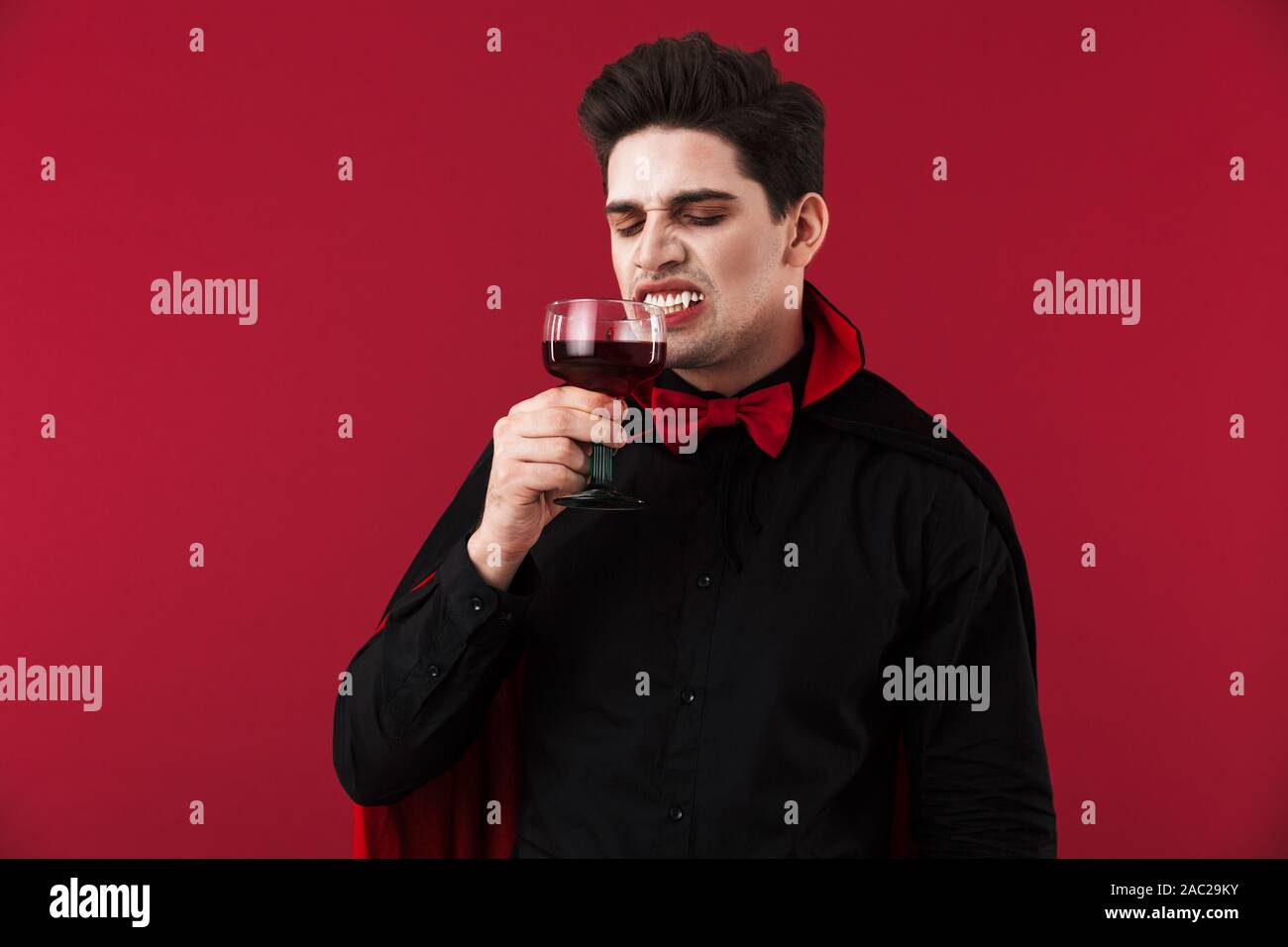 Image of young vampire man with fangs in black halloween costume ...