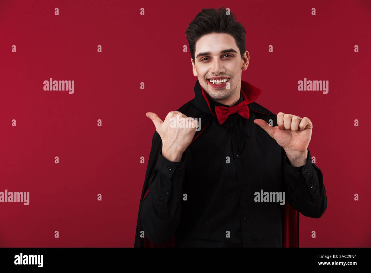Image of vampire man with blood and fangs in black halloween costume ...