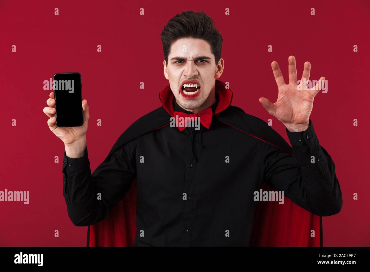 Image of vampire man with blood and fangs in black halloween costume ...