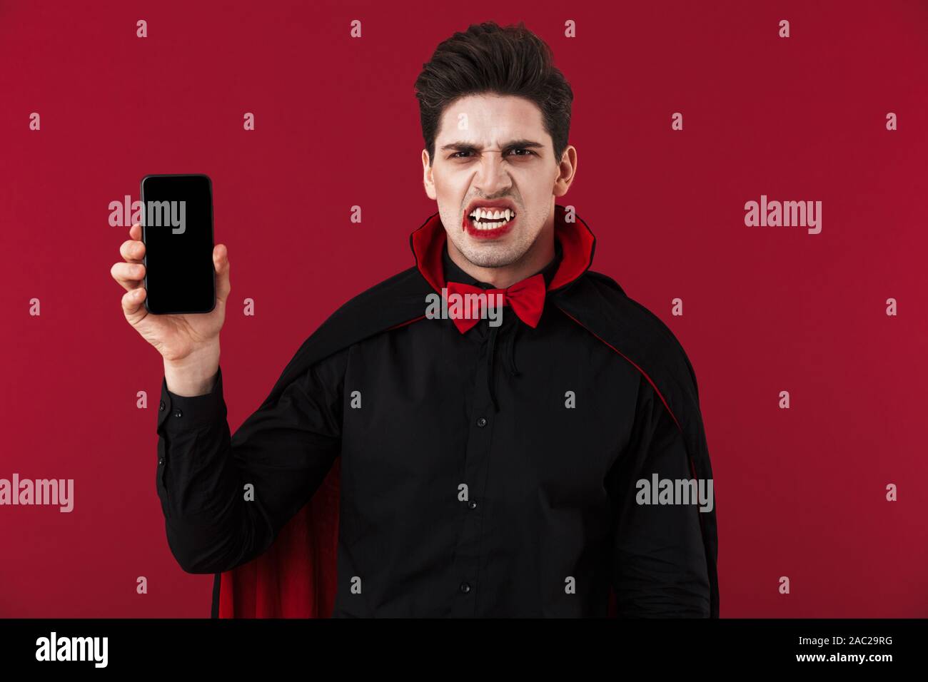 Image of vampire man with blood and fangs in black halloween costume ...