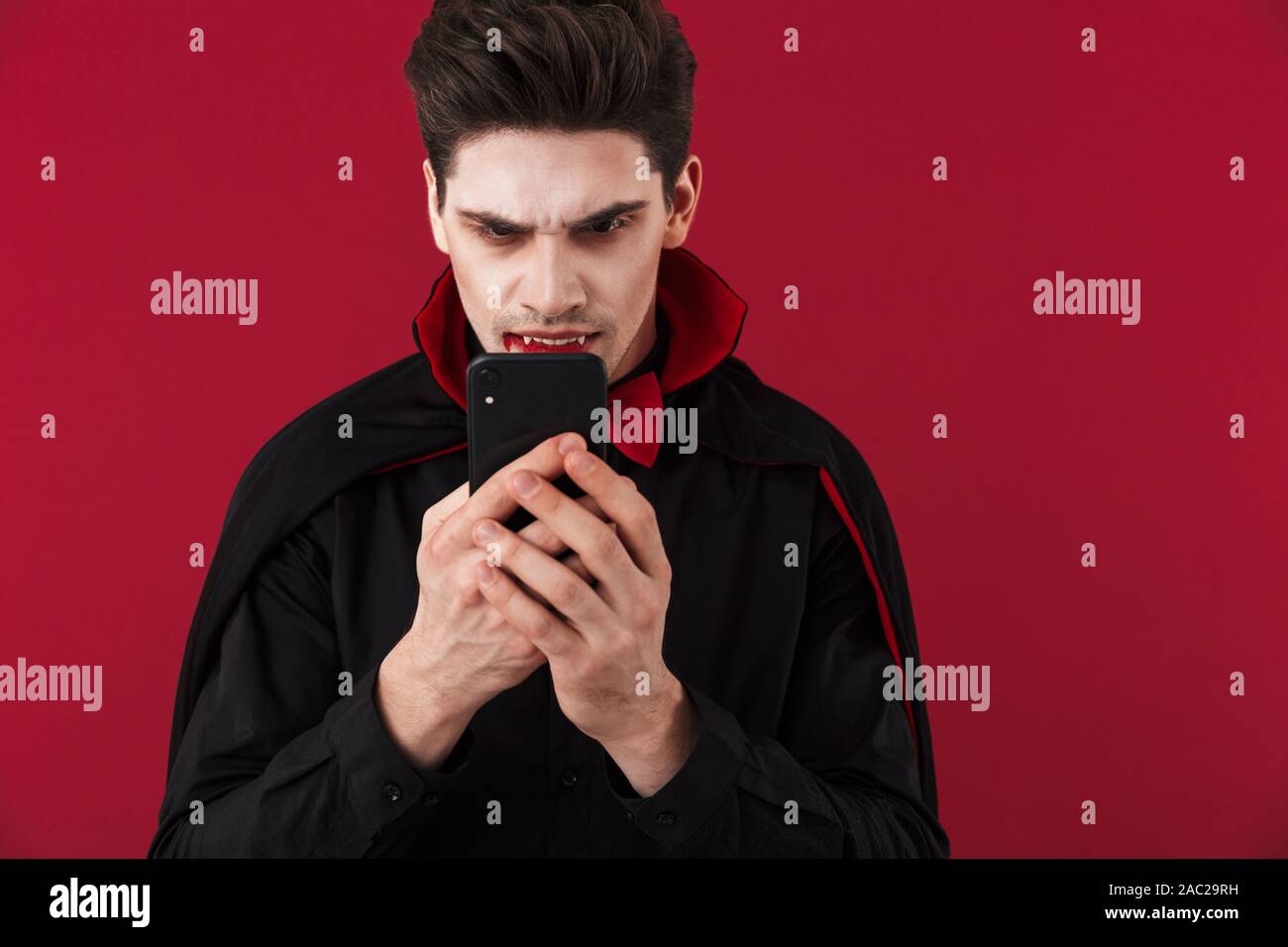 Image of vampire man with blood and fangs in black halloween costume ...