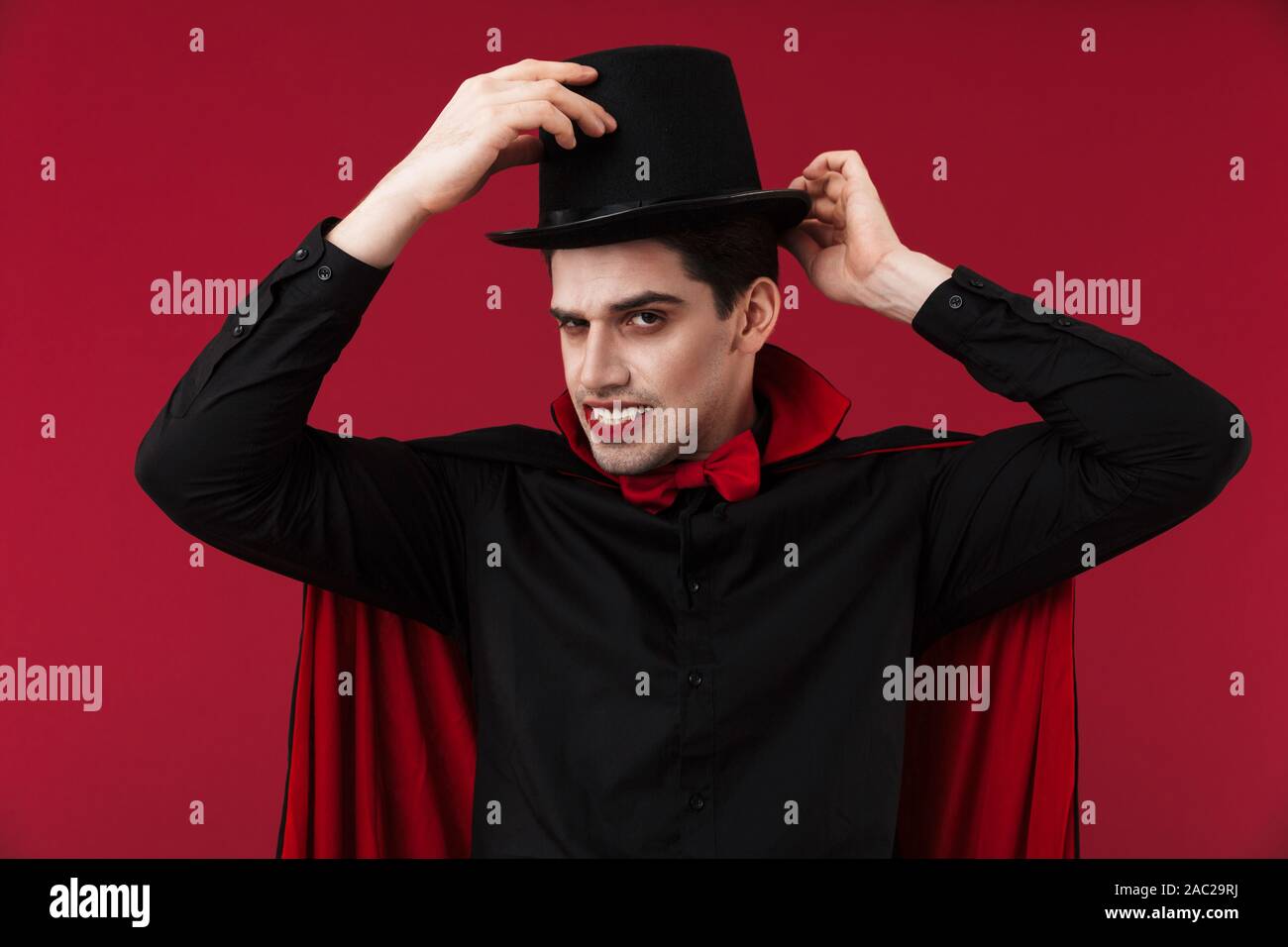 Image of vampire man with blood and fangs in black halloween costume ...