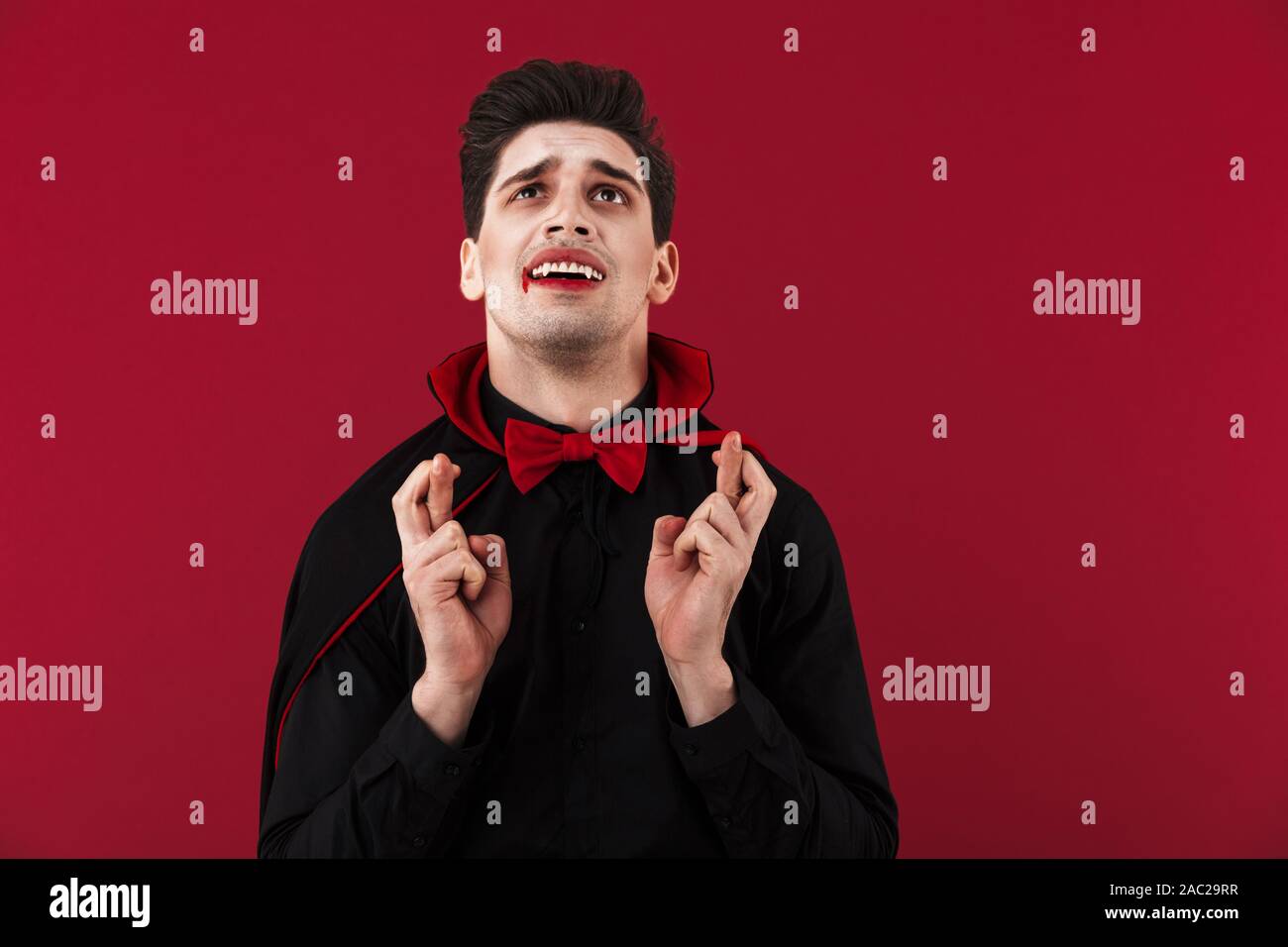 Image of vampire man with blood and fangs in black halloween costume ...