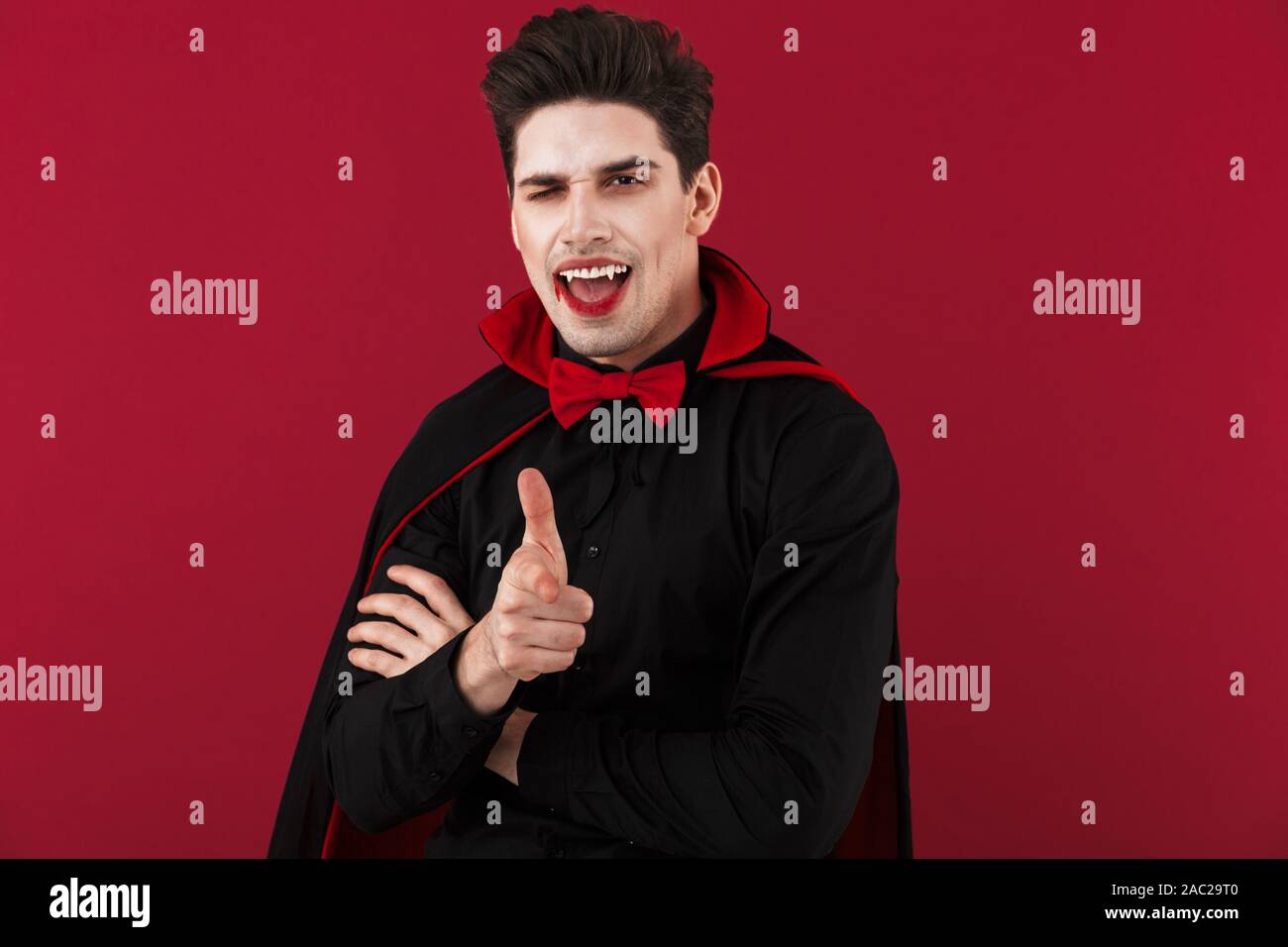 Image of happy vampire man with blood and fangs in black halloween ...