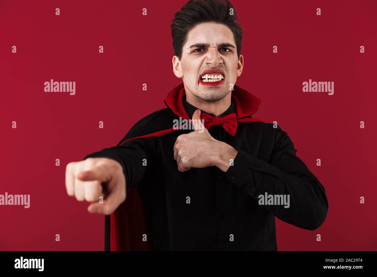 Image of vampire man with blood and fangs in black halloween costume ...