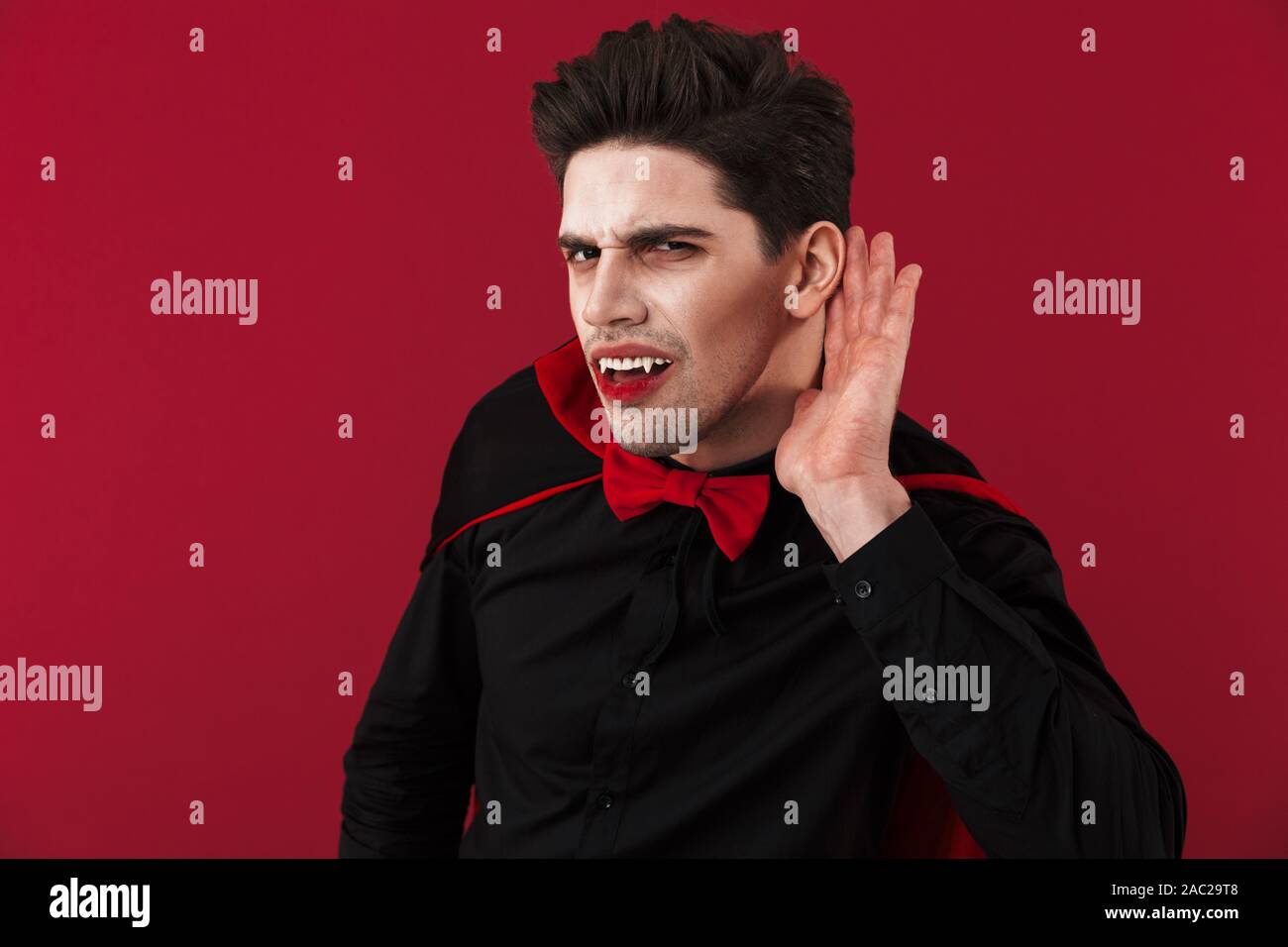 Image of young vampire man with blood and fangs in black halloween ...