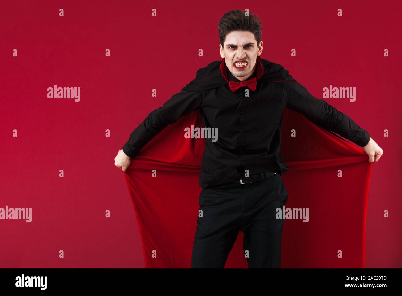 Image of angry vampire man with blood and fangs in black halloween ...