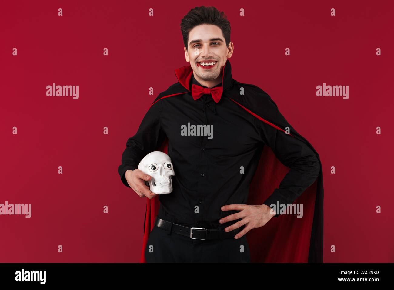 Image of vampire man with fangs in black halloween costume holding ...