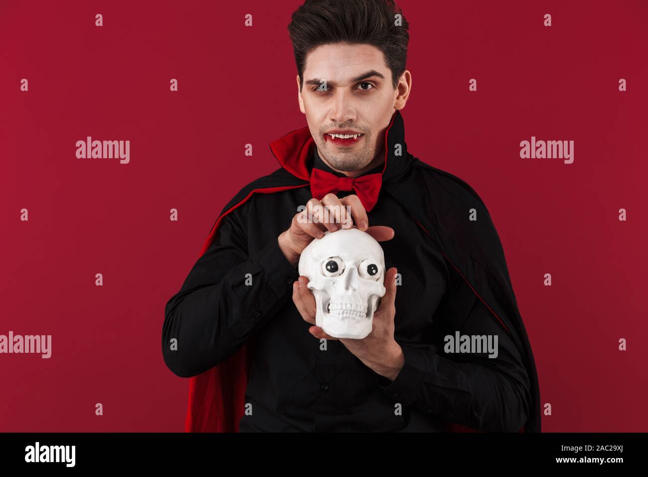Image of vampire man with fangs in black halloween costume holding ...