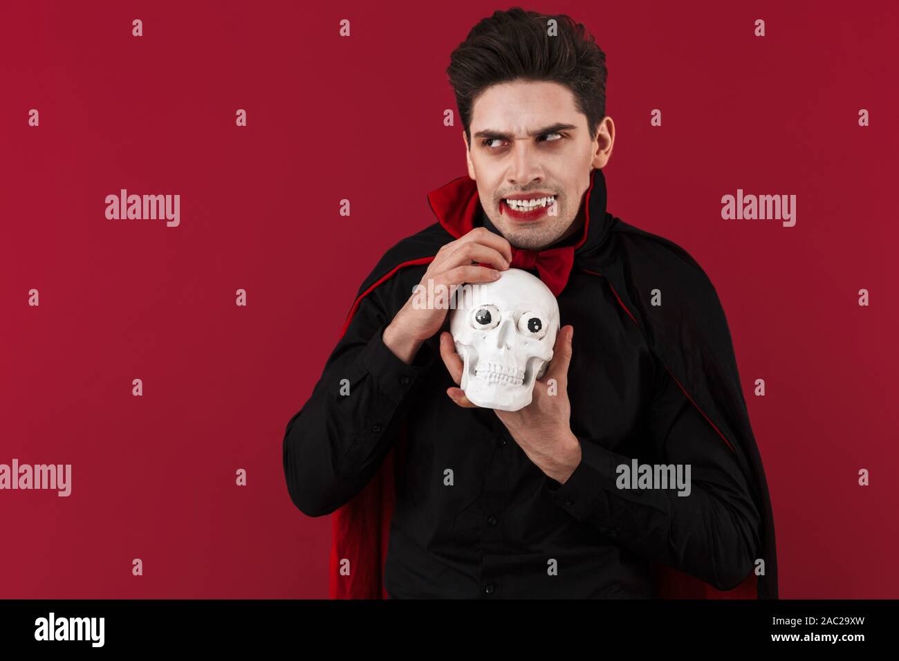 Image of vampire man with fangs in black halloween costume holding ...