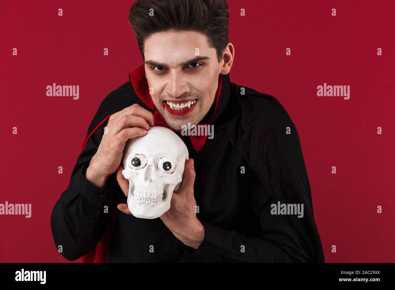 Image of vampire man with fangs in black halloween costume holding ...