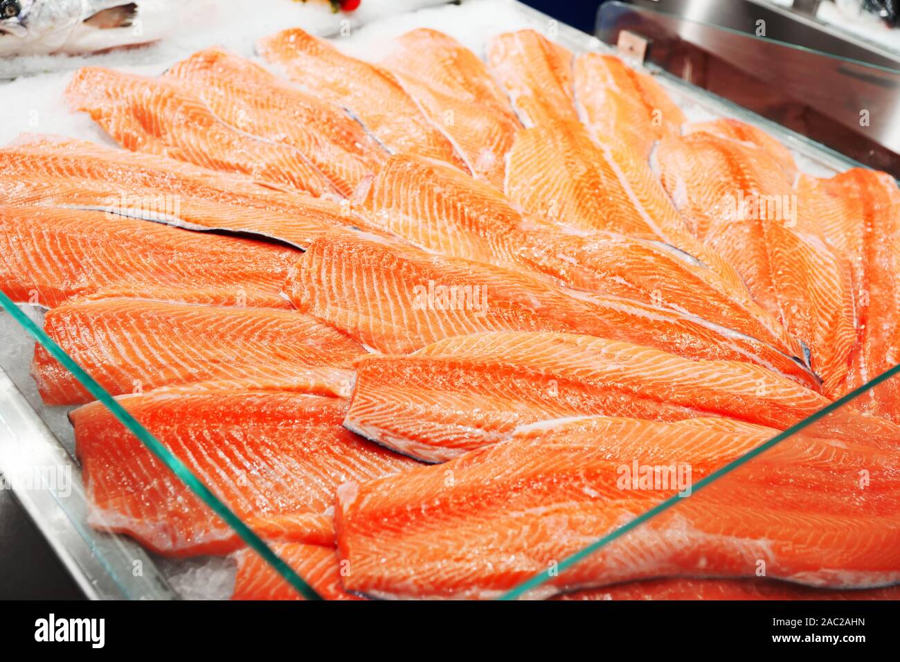 Salmon fillets on iced market display in food store, toned image Stock ...