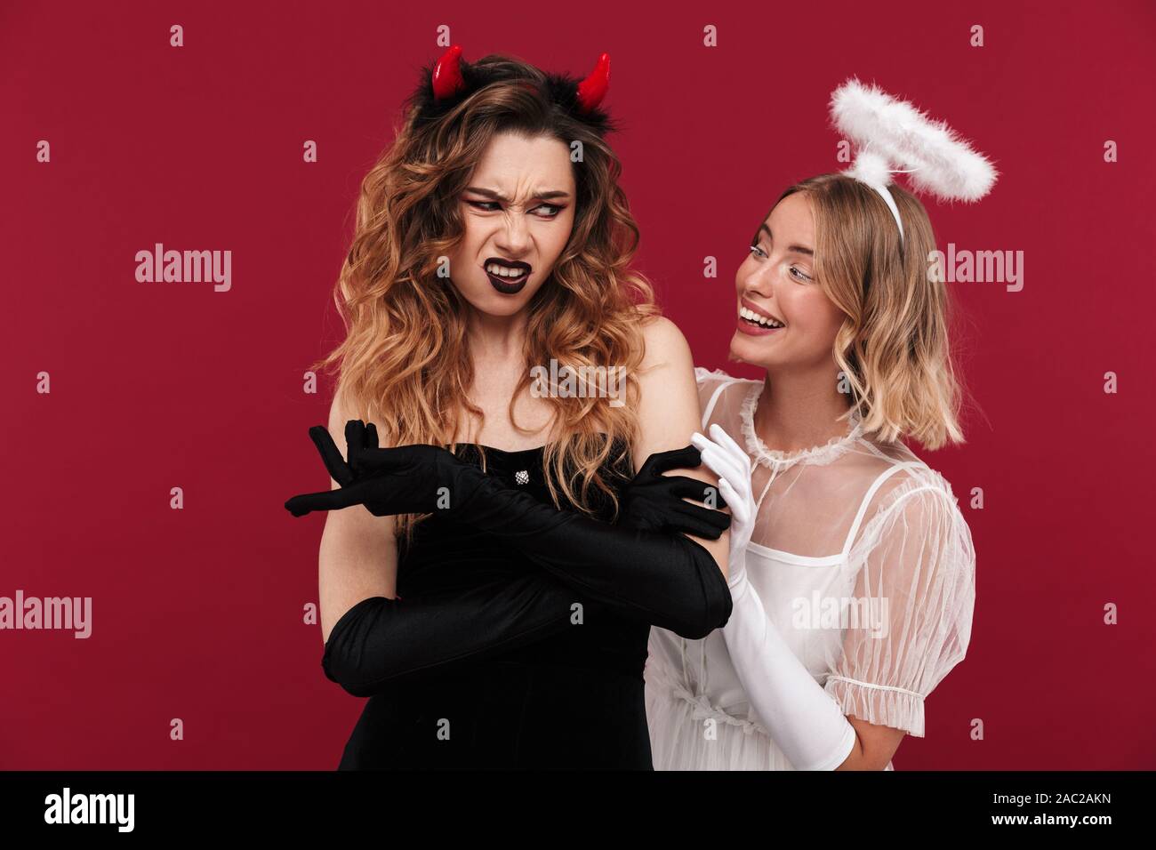 Image of angry displeased confused woman demon near happy cheery ...