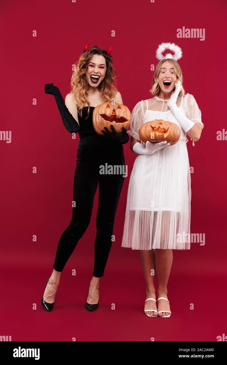 Image of happy cheery woman demon and positive angel in carnival ...