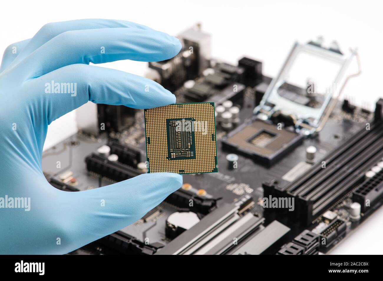 Hand in rubber blue glove with square main computer component, brain ...