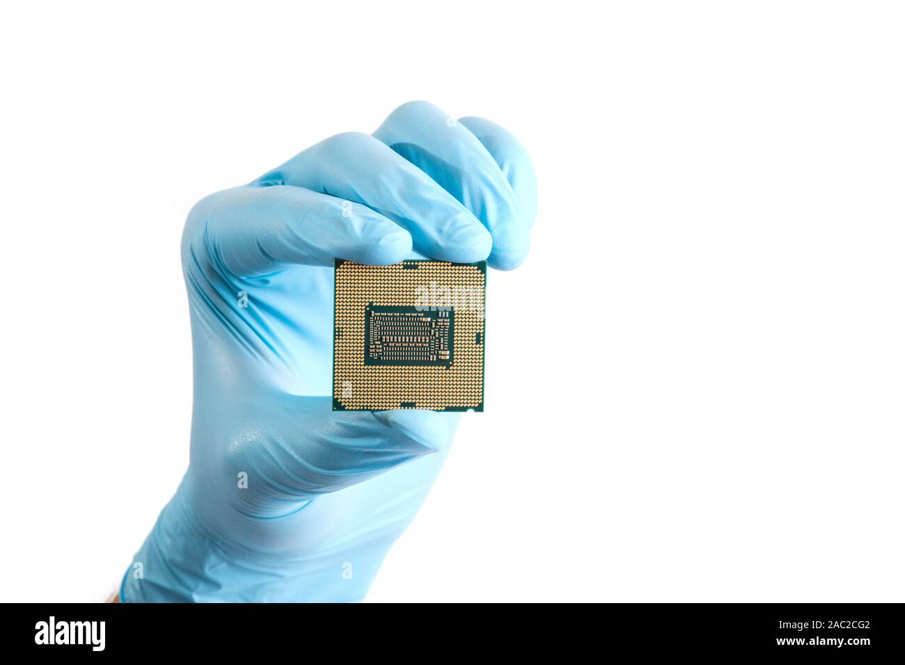 Hand in blue gloves holds micro processor cpu, close up. White ...