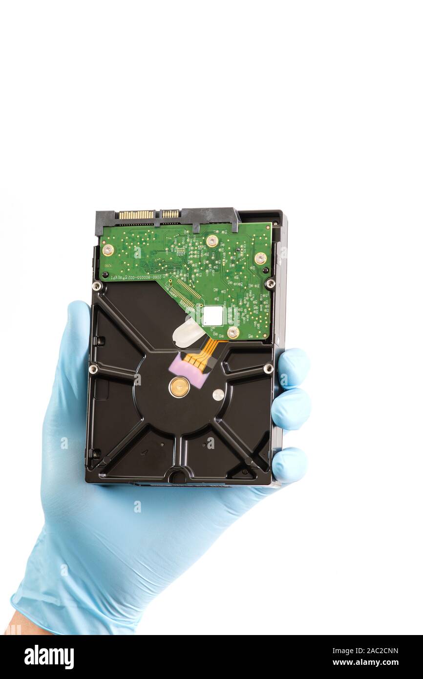 Repairman hand in blue runnber glove holds computer hard drive disk ...