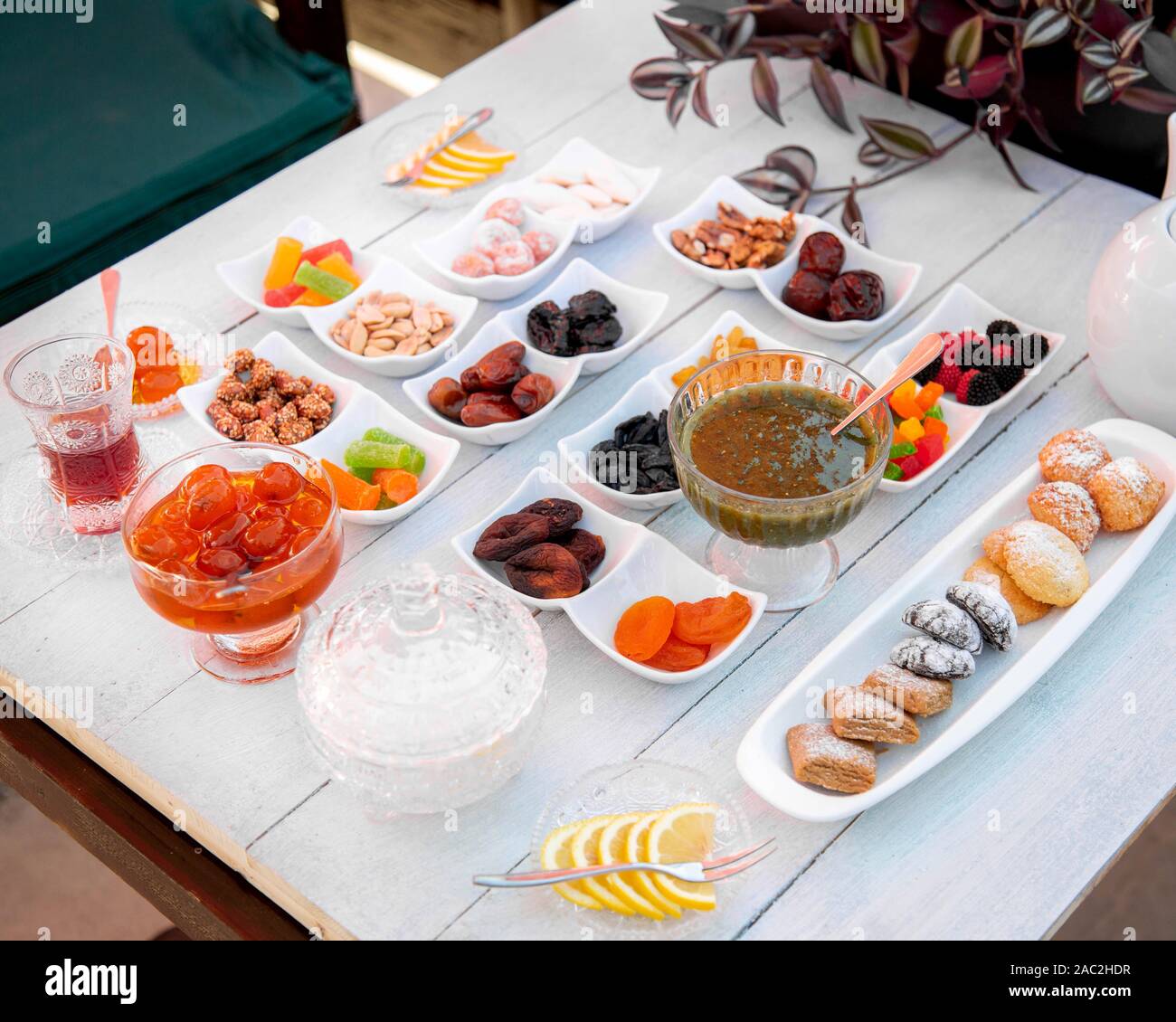 set with lots of sweets with black tea Stock Photo - Alamy