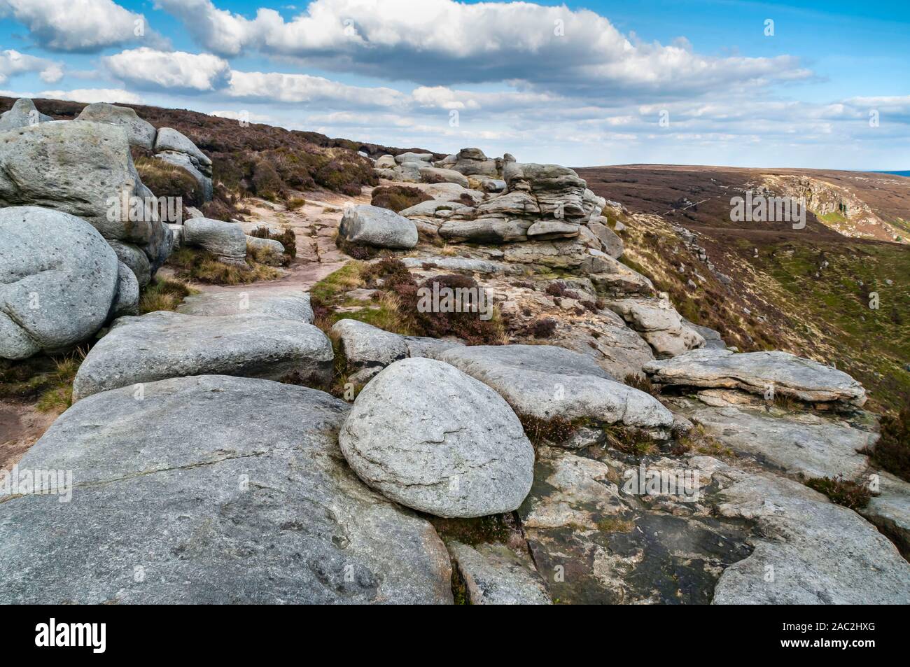 Path along Kinder Edge looking east with gritstone boulders and slabs ...