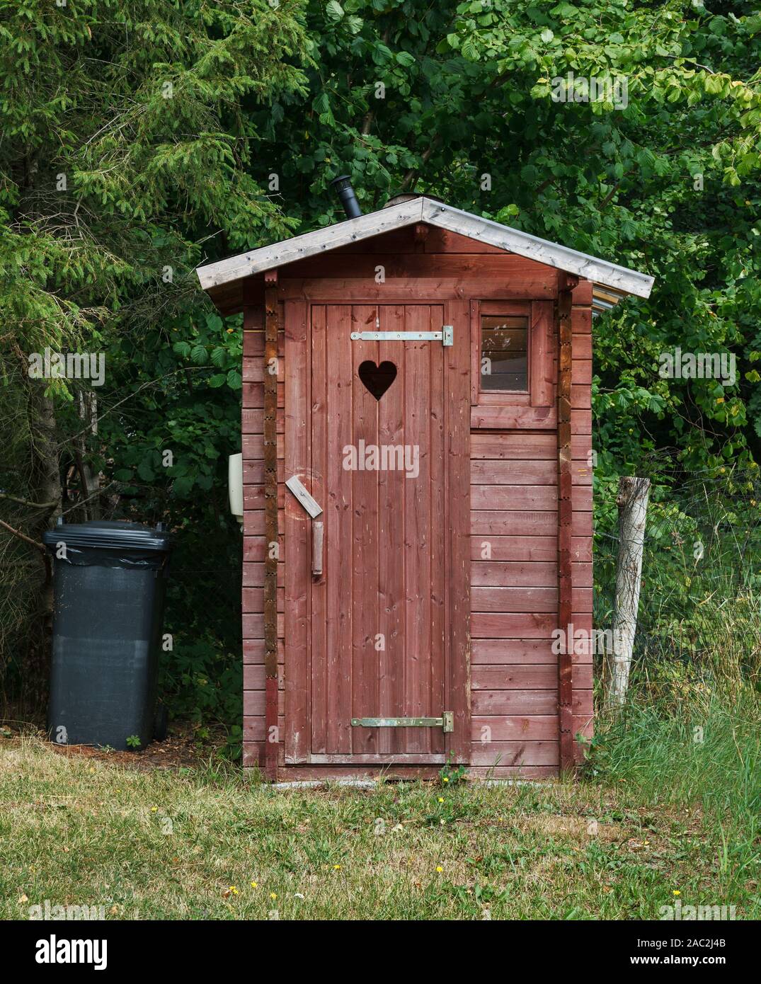 Nice small red outside toilet Stock Photo - Alamy