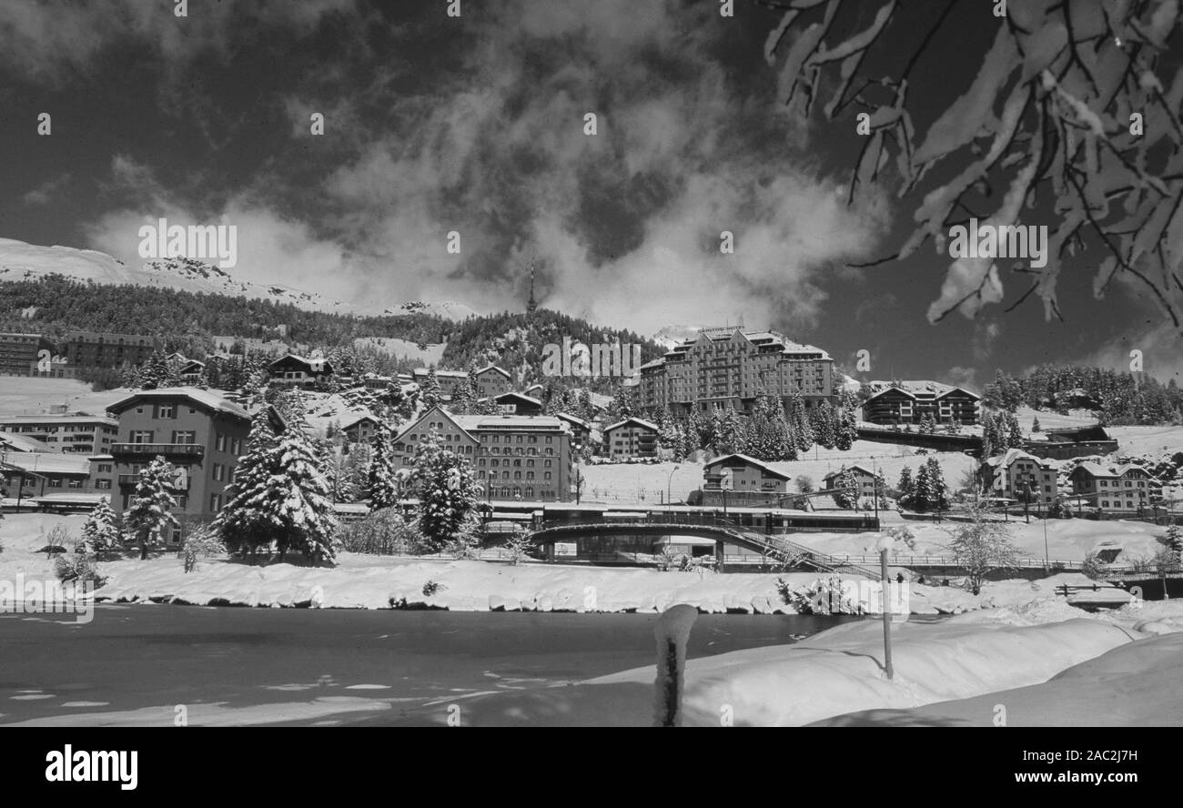 Swiss alps: The frozen Lake of St. Moritz with the Carlton Hotel above ...