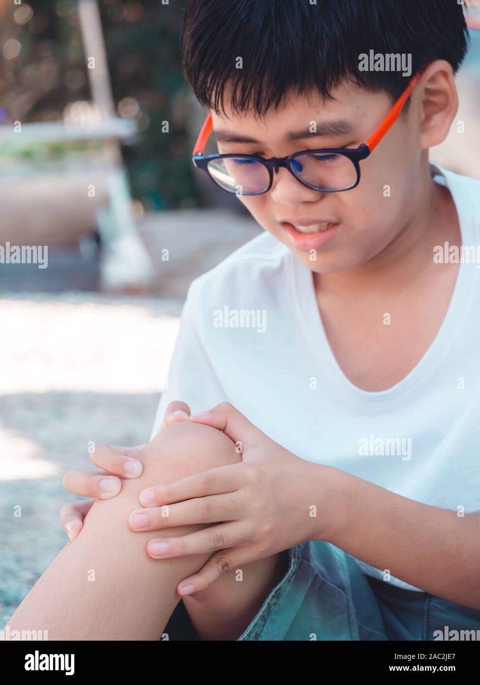 Kid boy feel knee pain after play. healthy problem concept Stock Photo ...