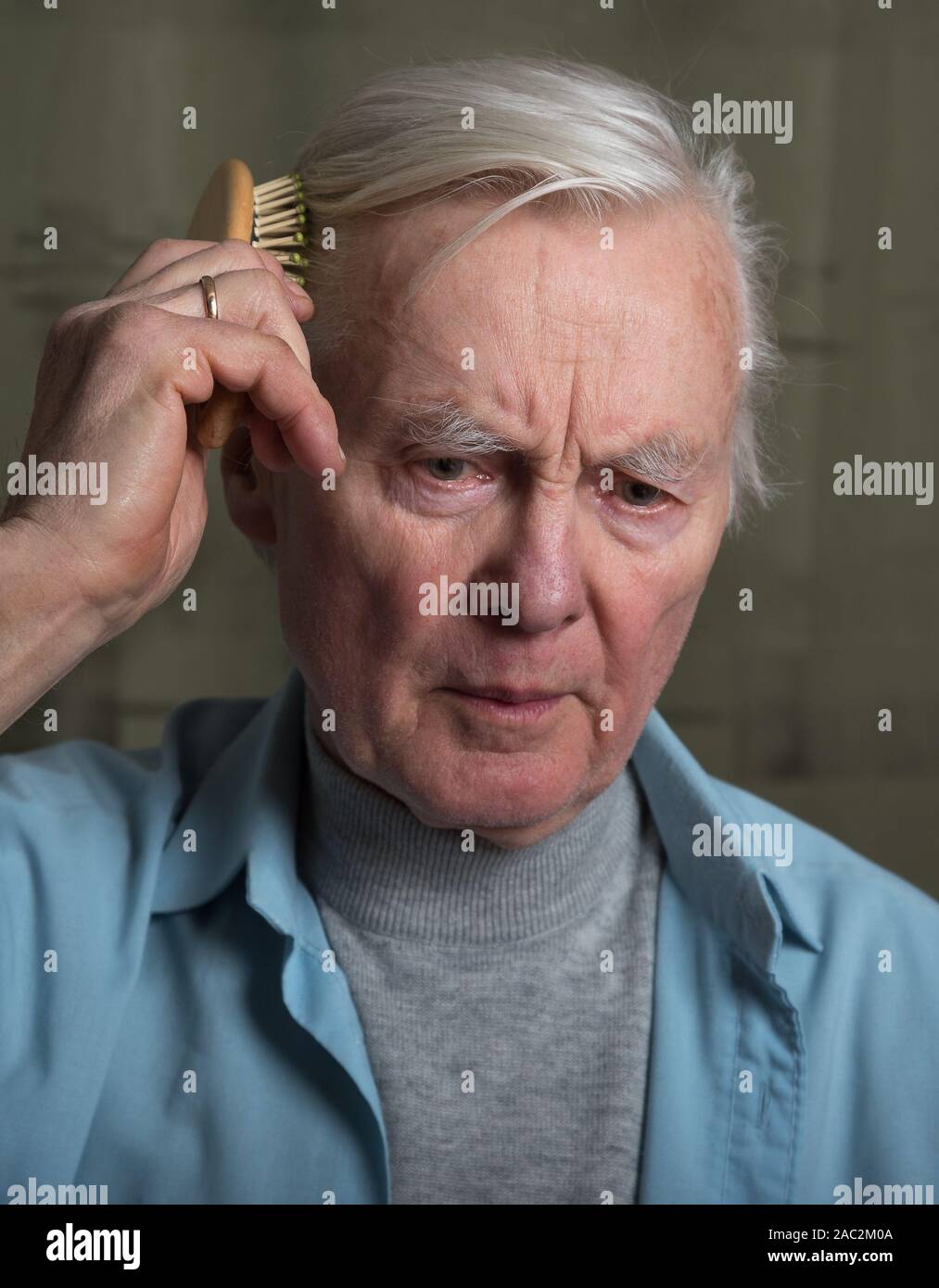 Senior man combing hair hi-res stock photography and images - Alamy