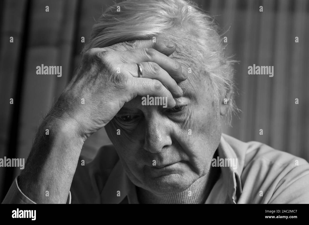 Sad elderly man looking down Stock Photo - Alamy