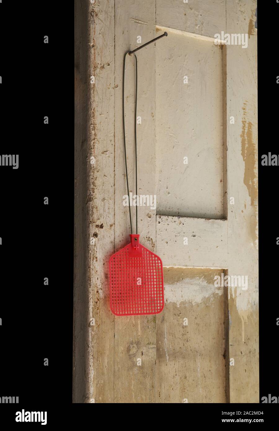 red fly swatter on a nail Stock Photo - Alamy