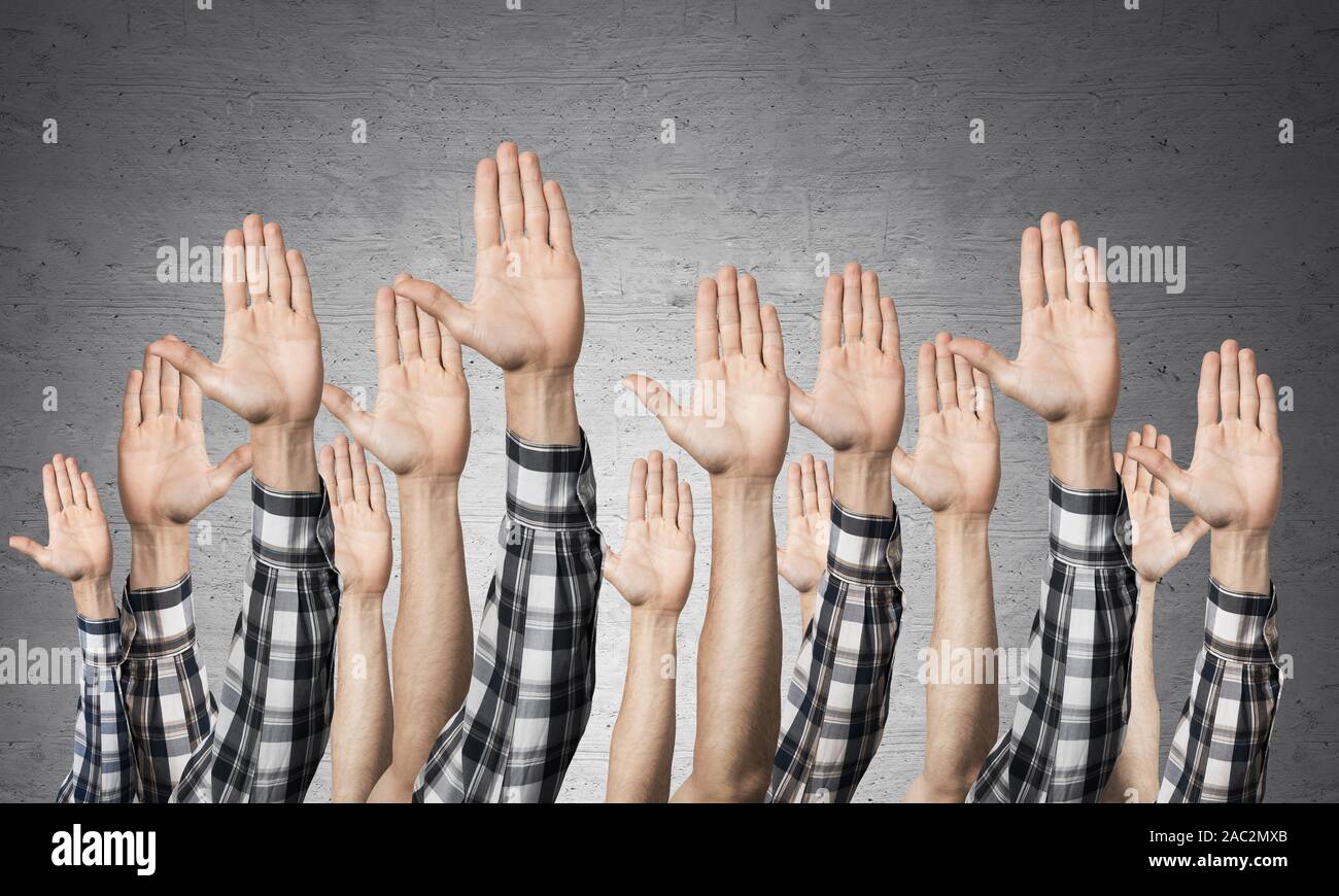 Row of man hands showing voting gesture Stock Photo - Alamy