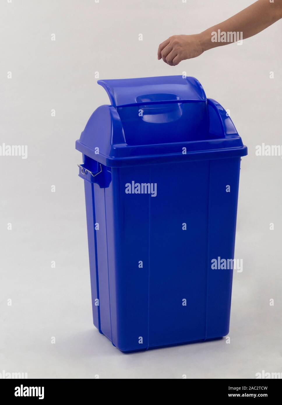 woman hand throwing something into the trash can isolated on white ...