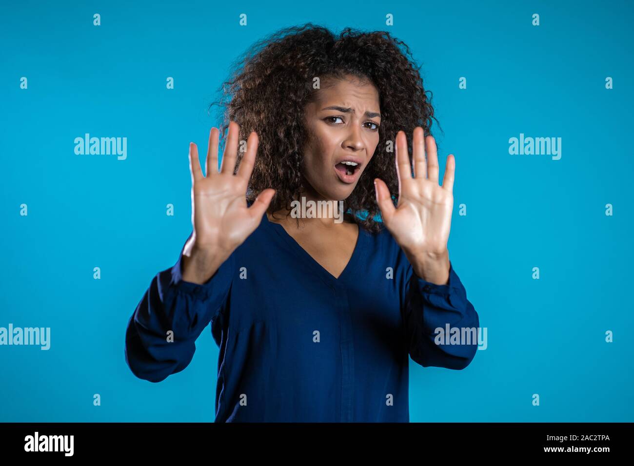 Angry young woman raising hand hi-res stock photography and images - Alamy