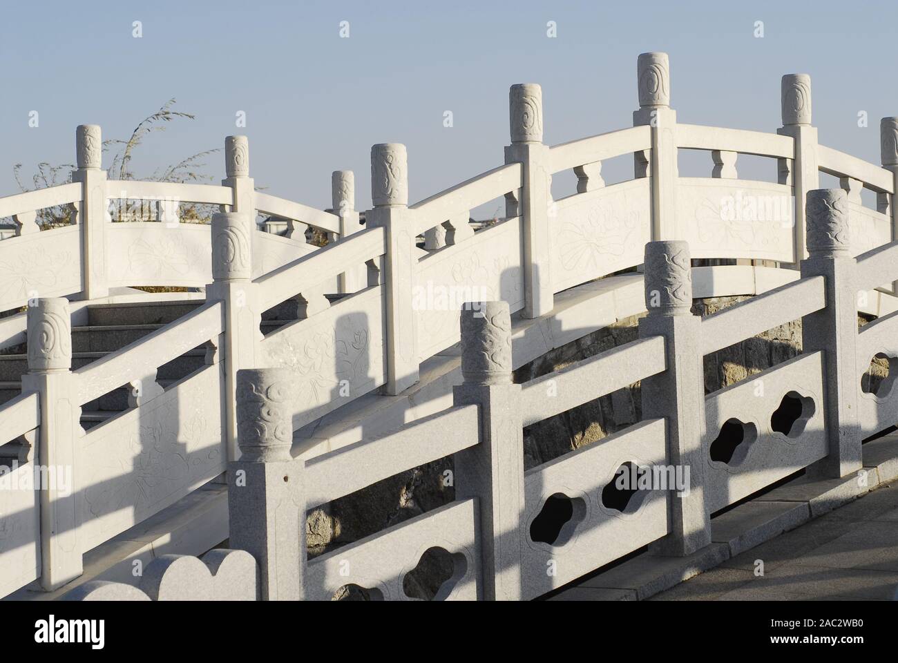 a small arch bridge with carved designs in a national park in China ...