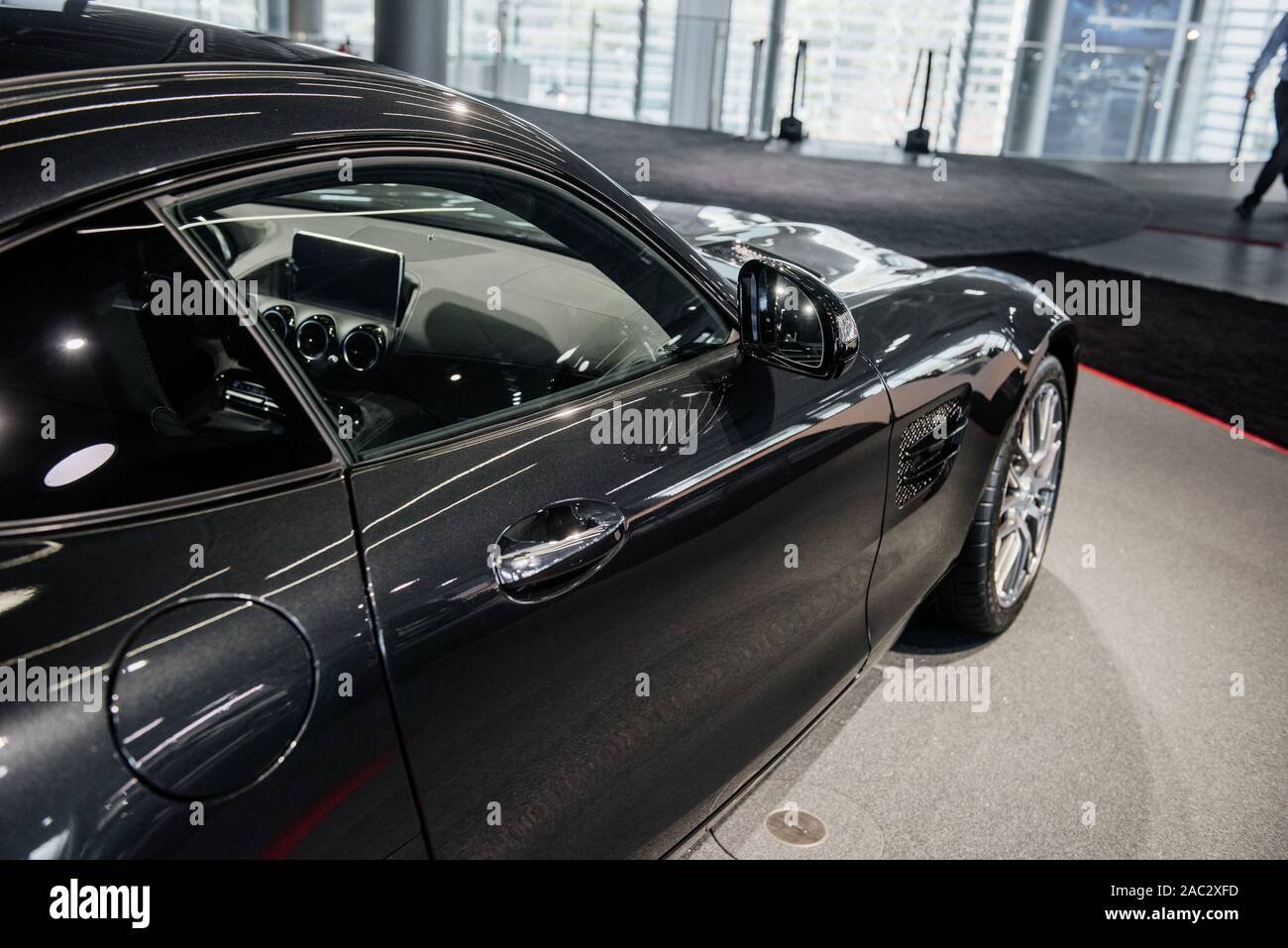 Good lighting. Side photo of the modern black car standing on the stand ...