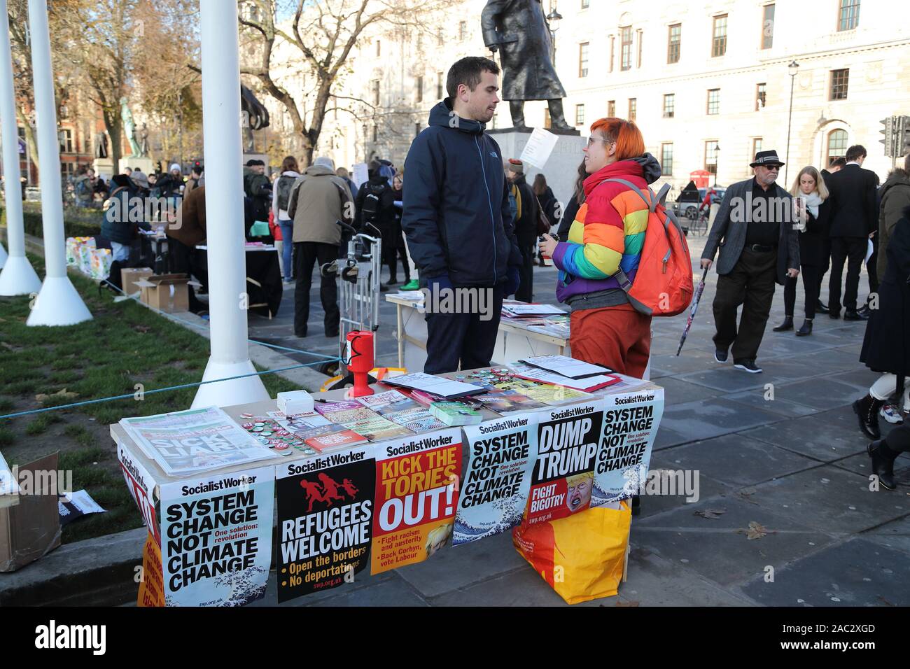 An activist distributes leaflets and flyers advocating system change in ...