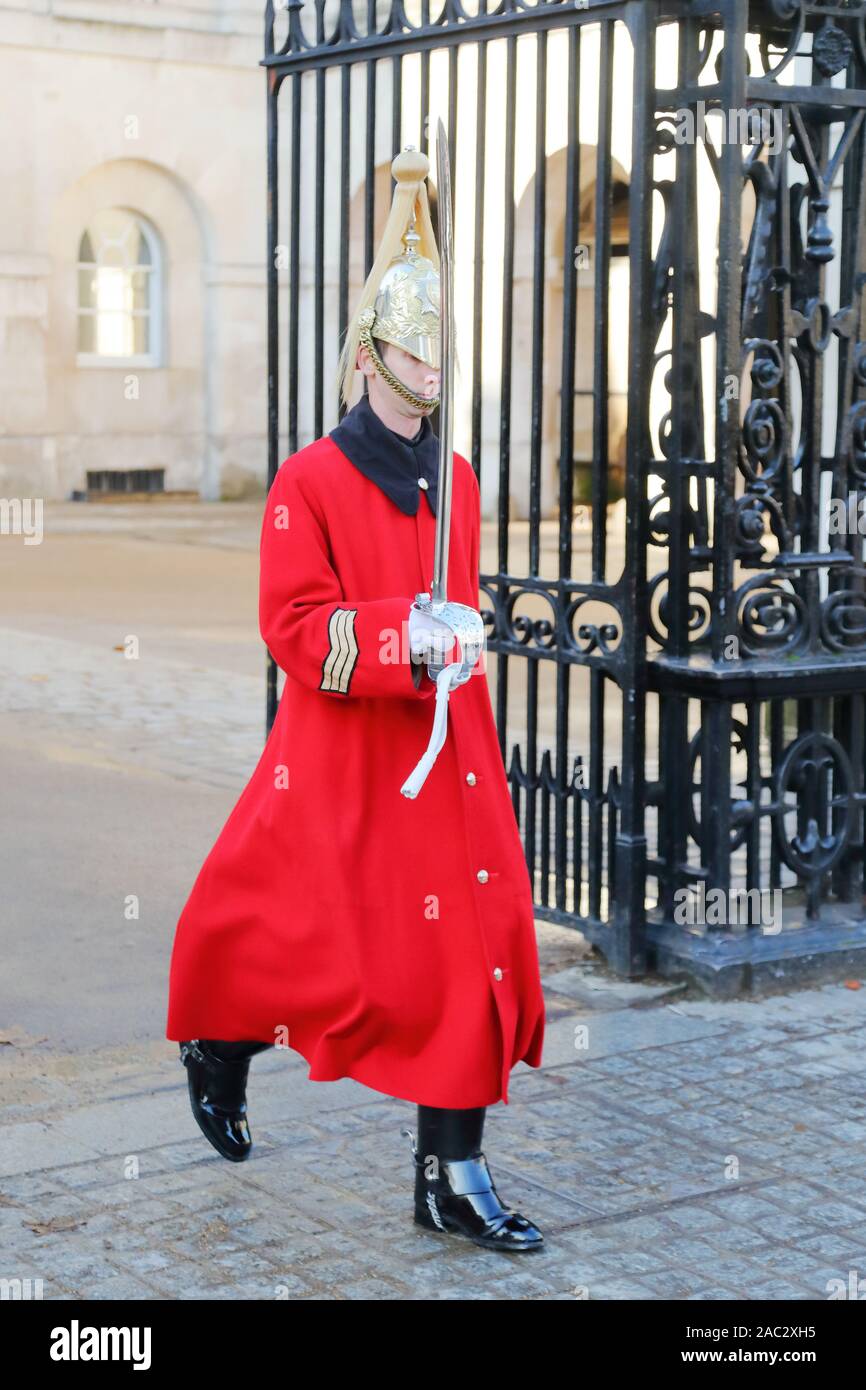 Household Cavalry guardsman on foot in their traditional long red ...