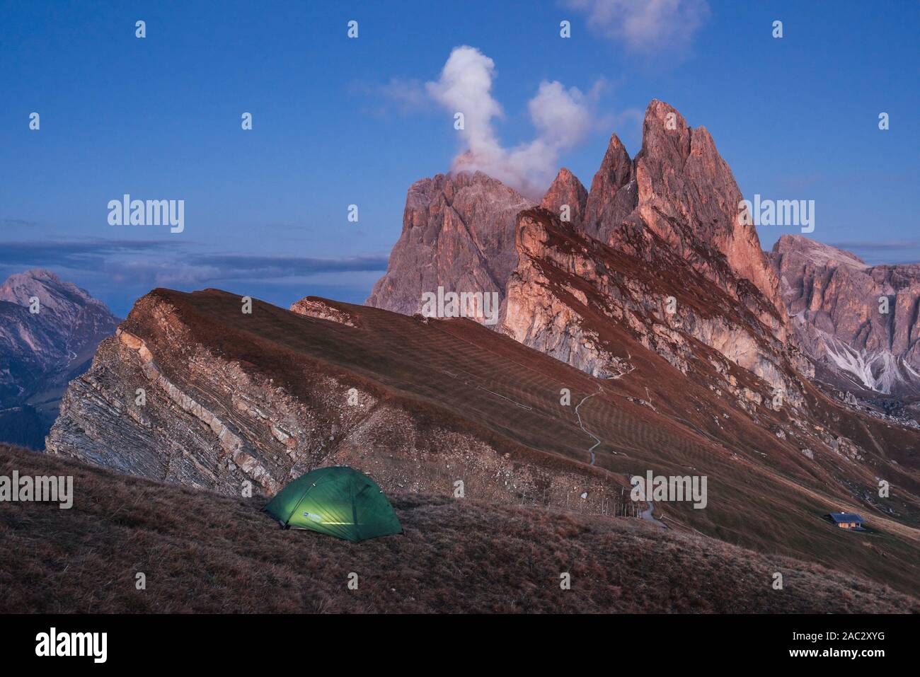 Evening and fog. Green tent standing on the hill. Awesome place in the ...