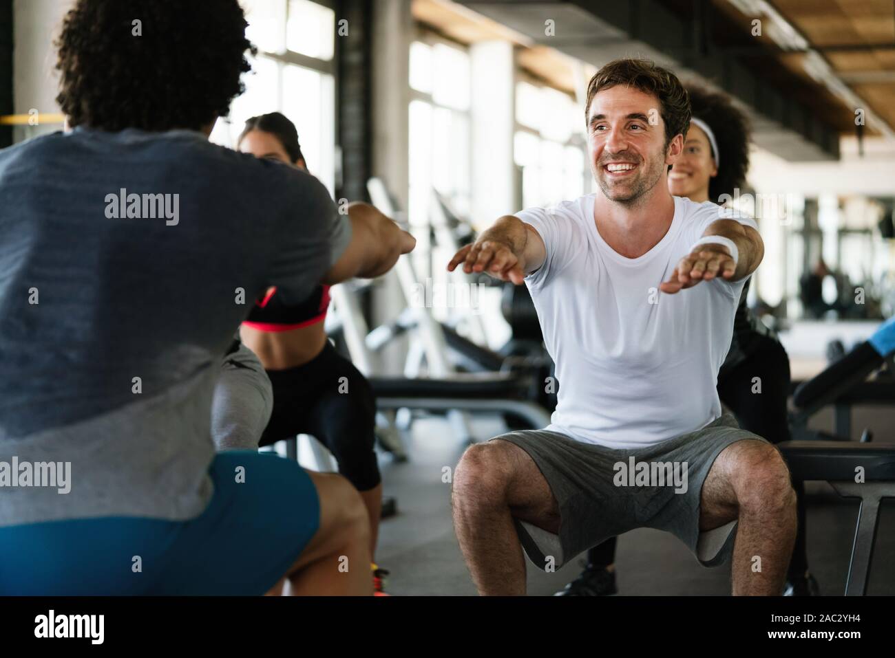 Group of fit people at the gym exercising Stock Photo - Alamy
