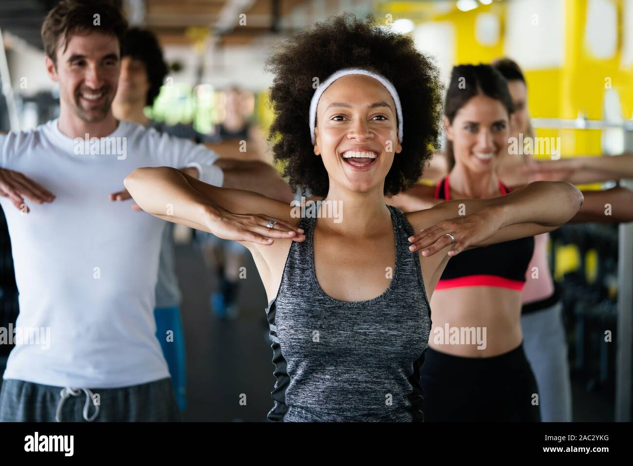 Group of happy multiracial friends exercising together in gym Stock ...