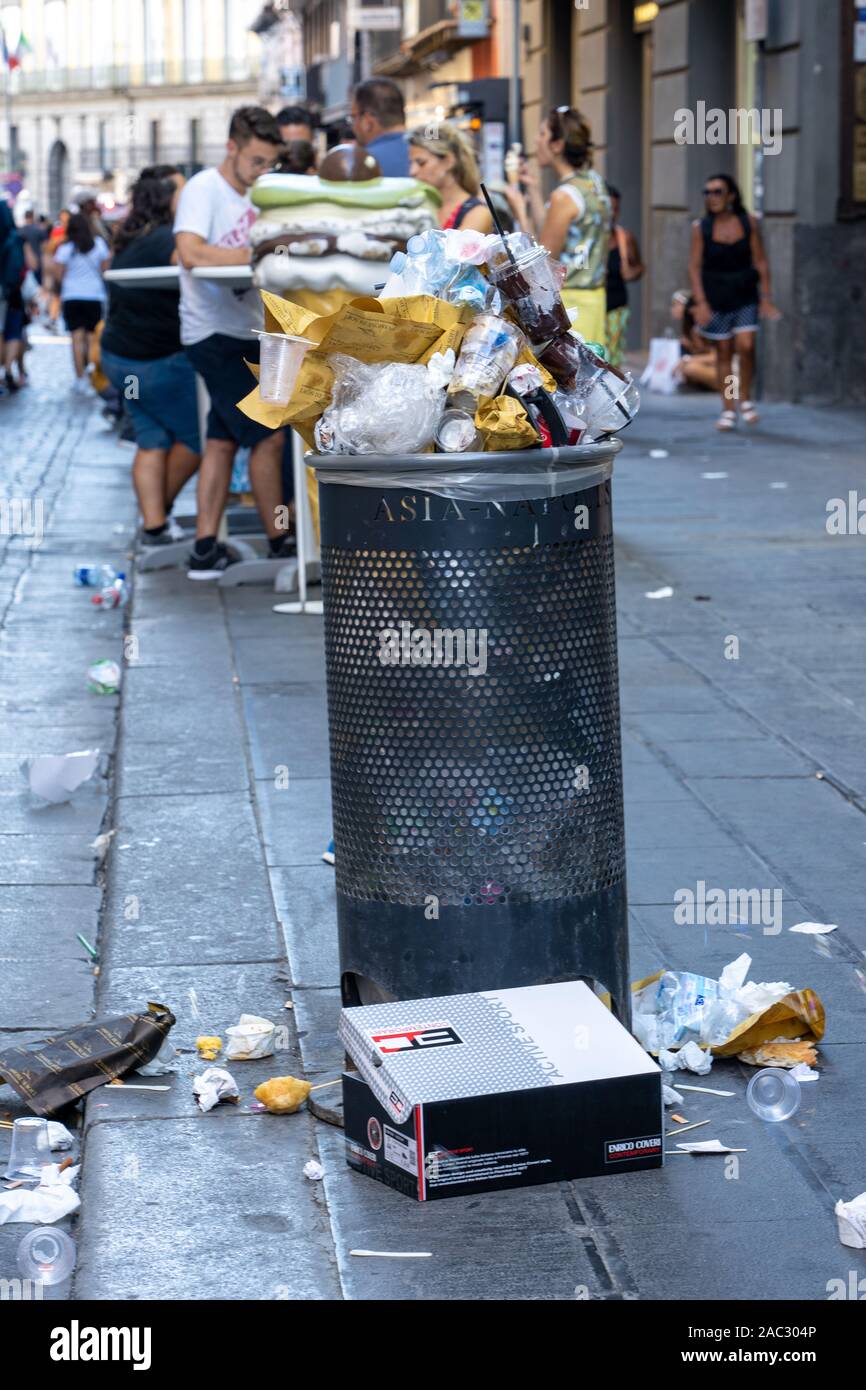 Naples, Italy - August 15, 2019: Overloaded trash can in Naples hitoric ...