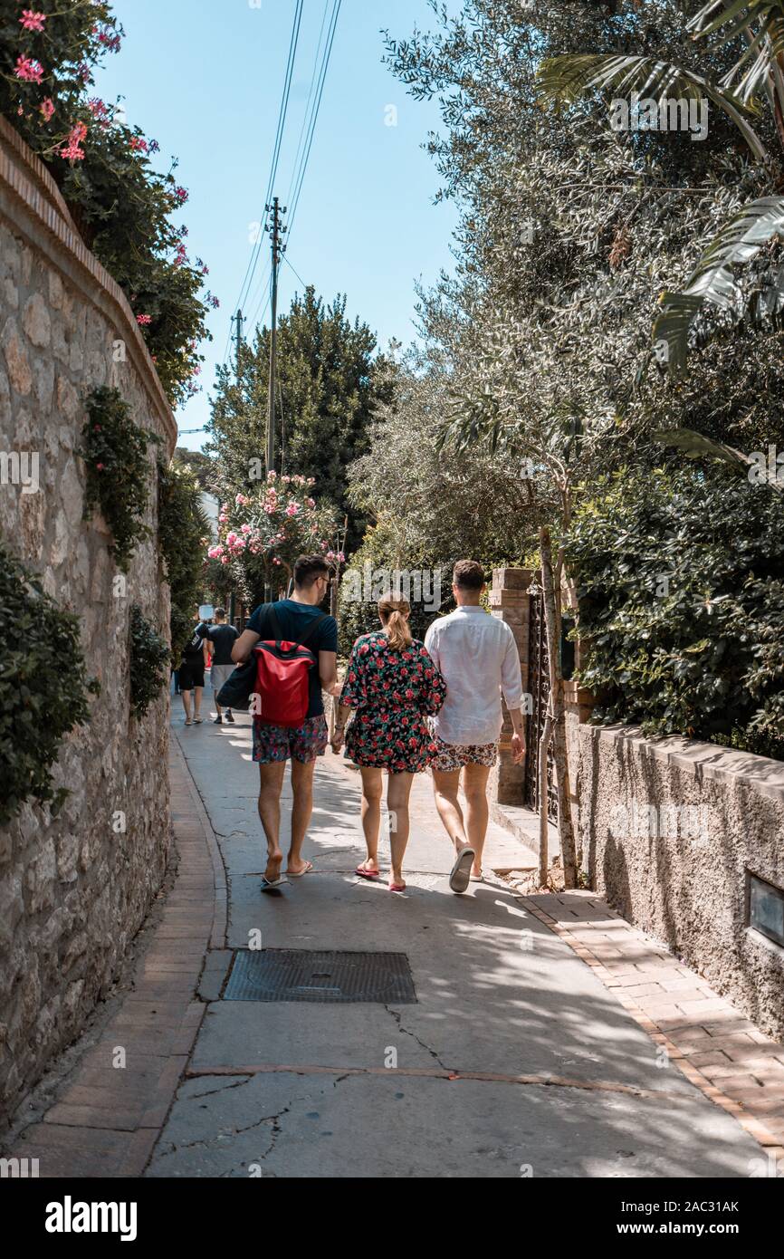 Capri, Italy - August 13, 2019: Tourists with floral clothes walk on ...