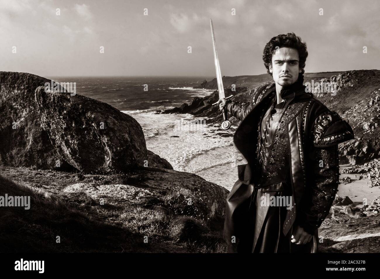 Black and white portrait of handsome knight holding sword and pointing ...