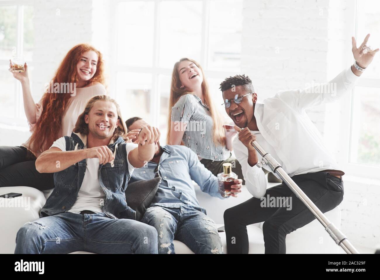 Time for a singing. Office friends have cheerful time sitting and ...