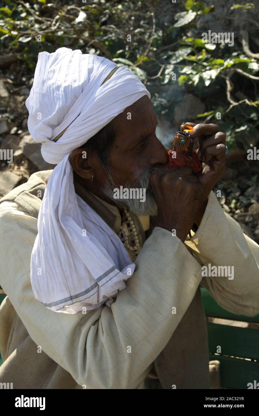Indian man smoking tobacco with pipe jaipur hi-res stock photography ...