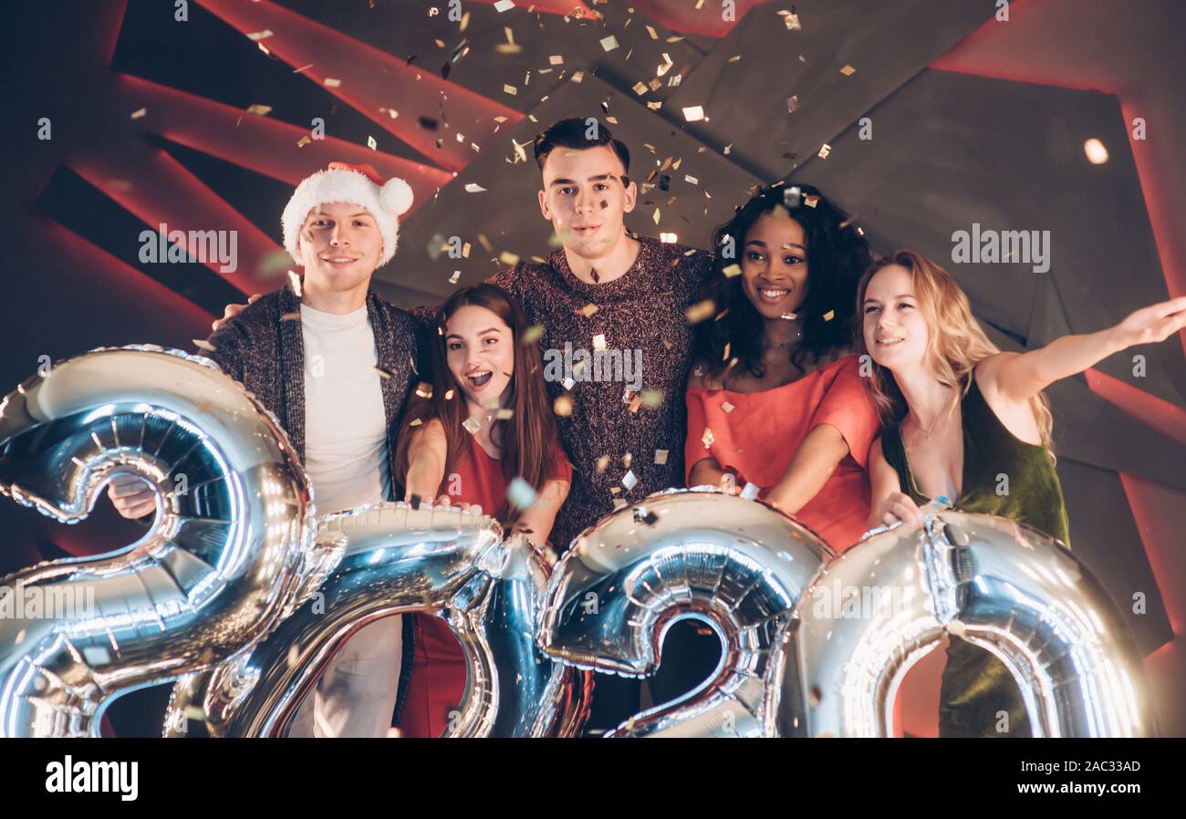 It's good together. Group of beautiful young friends with inflatable ...