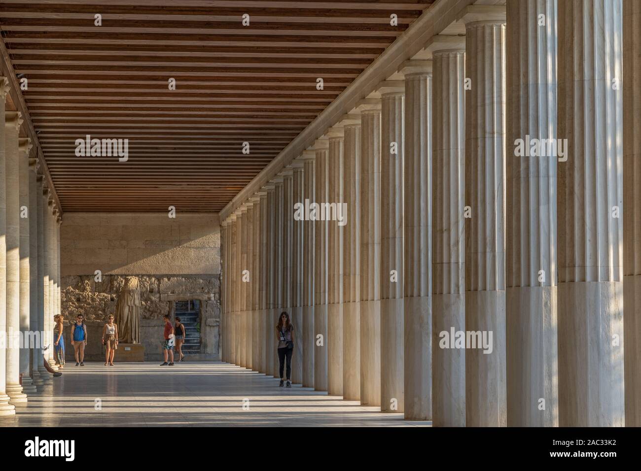Athens, Greece - August 17, 2019: Tourists walk in passage with marble ...